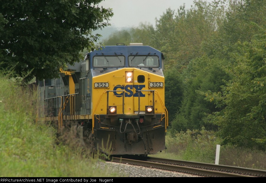 CSX 352 peeks from behind the trees as she gets her train restarted